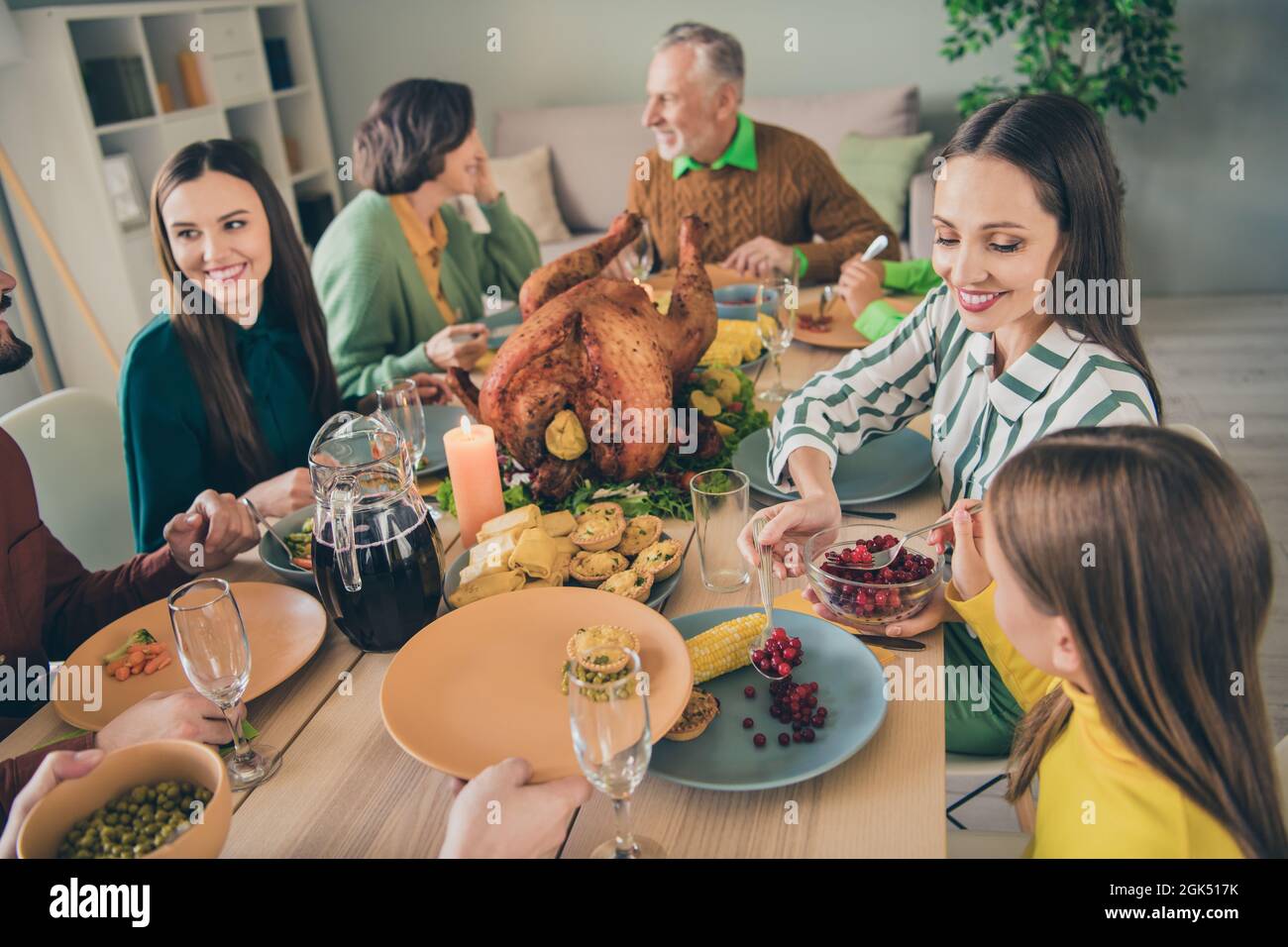 Photo of cute cheerful family eating holiday turkey sitting table ...