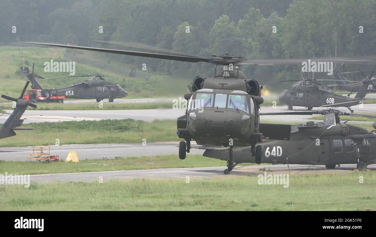 A student and instructor pilot hover-taxi a UH-60M Black Hawk ...