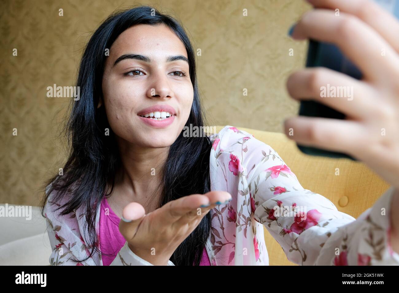 Closeup shot of a smiling young girl having a video call on a ...