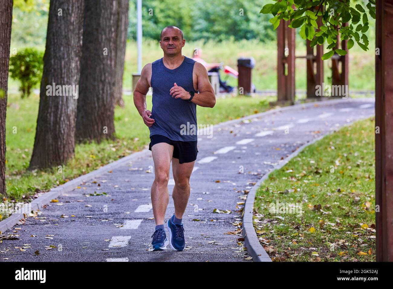 Man running in nature through the park, sports in the city Stock Photo ...