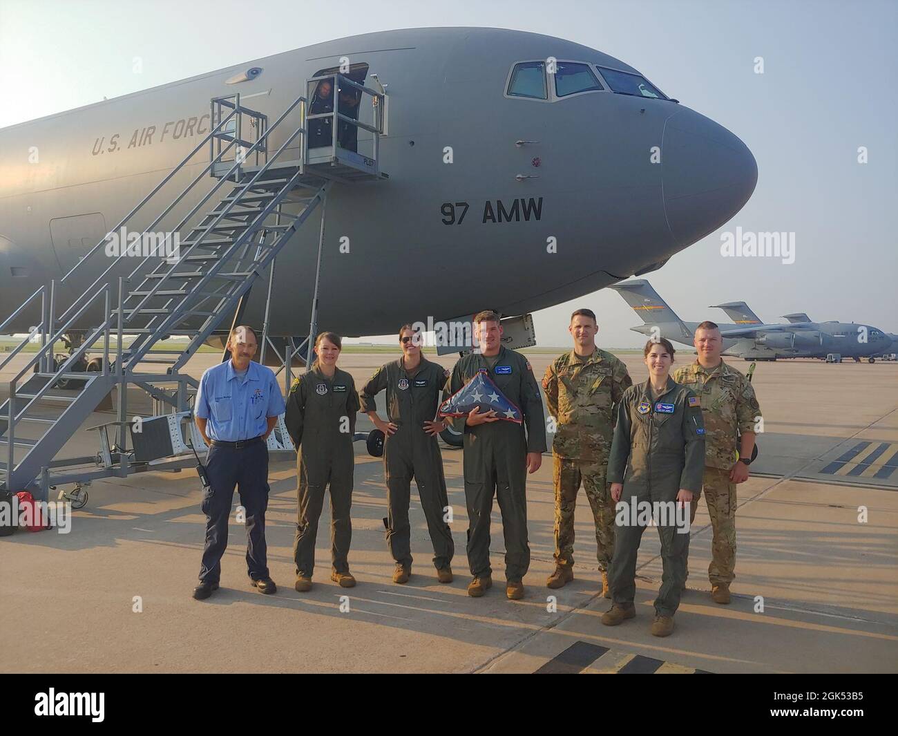 A KC-46 Pegasus aircrew pose with the Star-Spangled Ambassador flag at ...