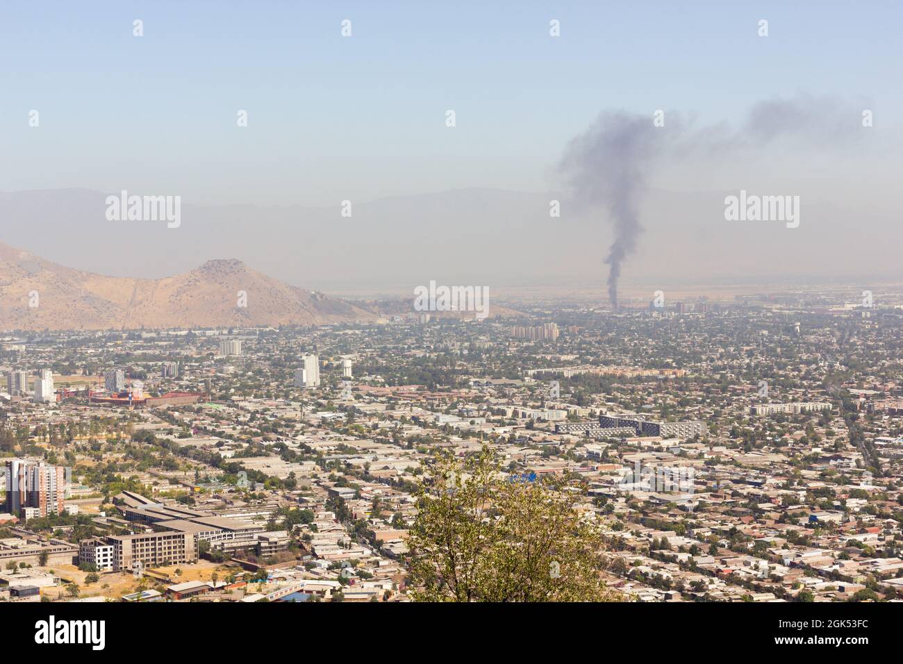 Flat city views of Santiago with fire smoke on background. Sunny day on ...