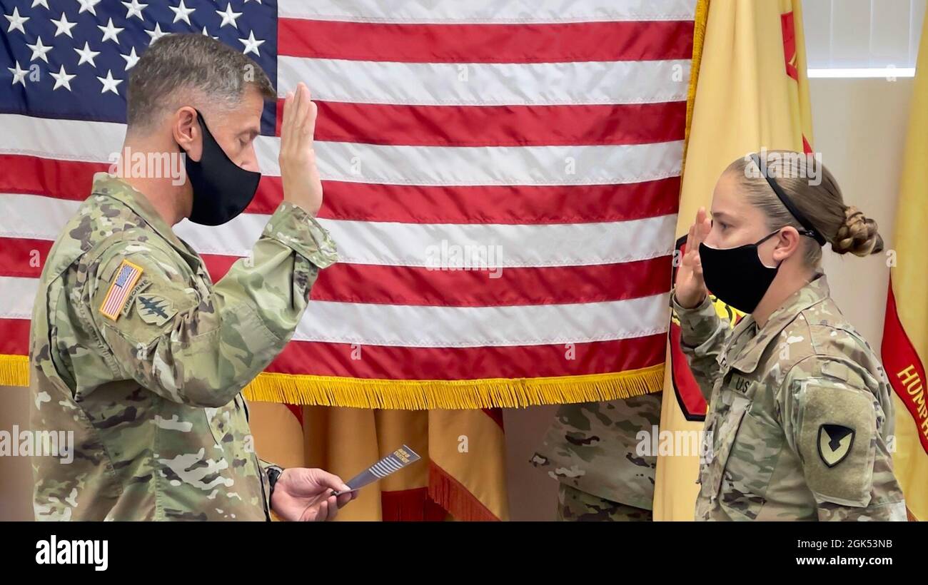 Col. Joseph Peterson administers the oath to Sgt. Caitlin Hames during ...