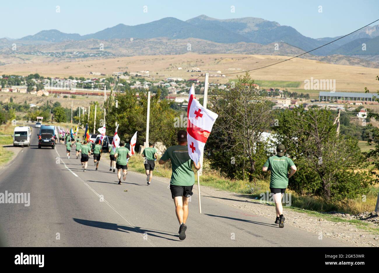 Partnered soldiers run to celebrate the International Day of Friendship ...
