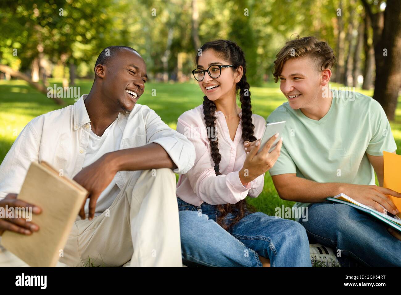 Diverse students friends using smartphone with new educational ...