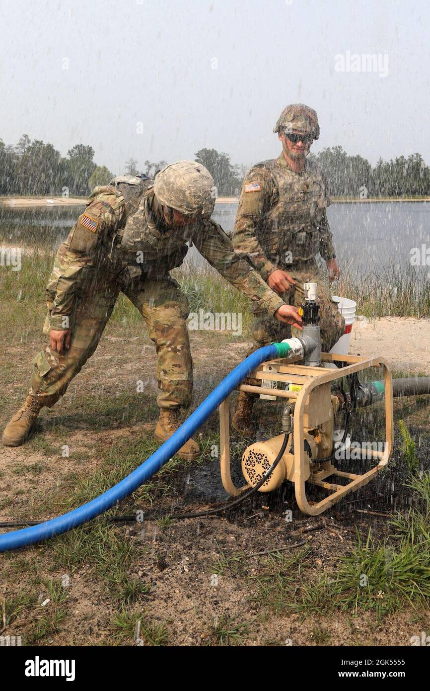 U. S. Army Cpl. Noah Borges and Spc. Garth Heinrich, water treatment ...