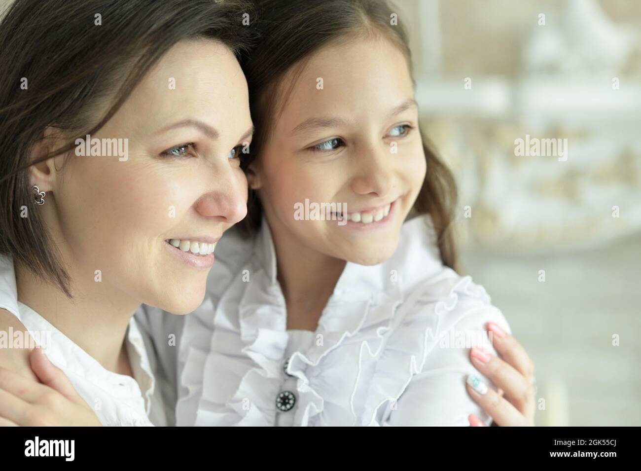 Beautiful young mother and cute little daughter posing Stock Photo - Alamy