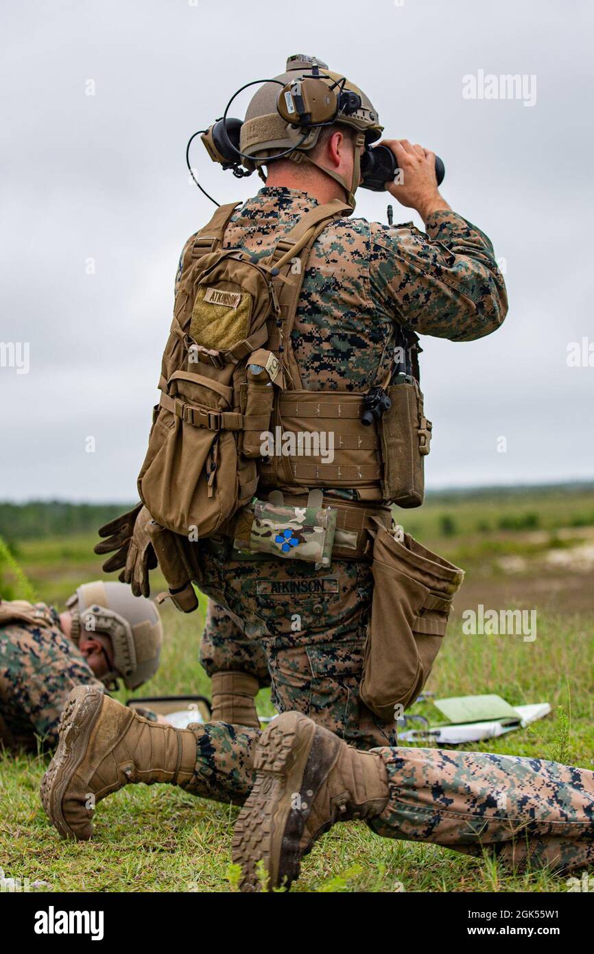 U.S. Marine Corps Capt. Vernon Atkinson observes an artillery round ...
