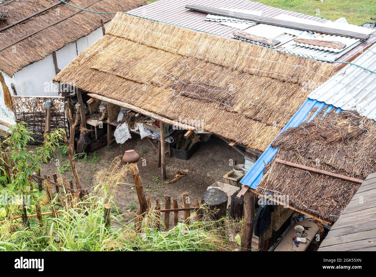 Roof of ancient barn covered with dry hay near country house Stock ...