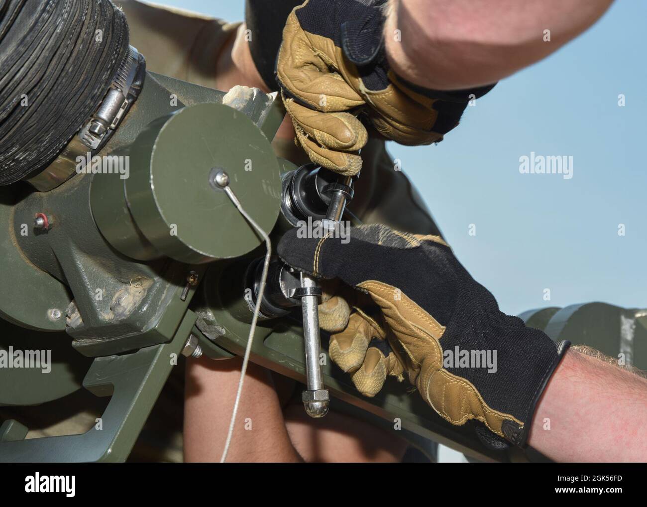 A 726th Air Control Squadron Airman further secures a jack screw by ...