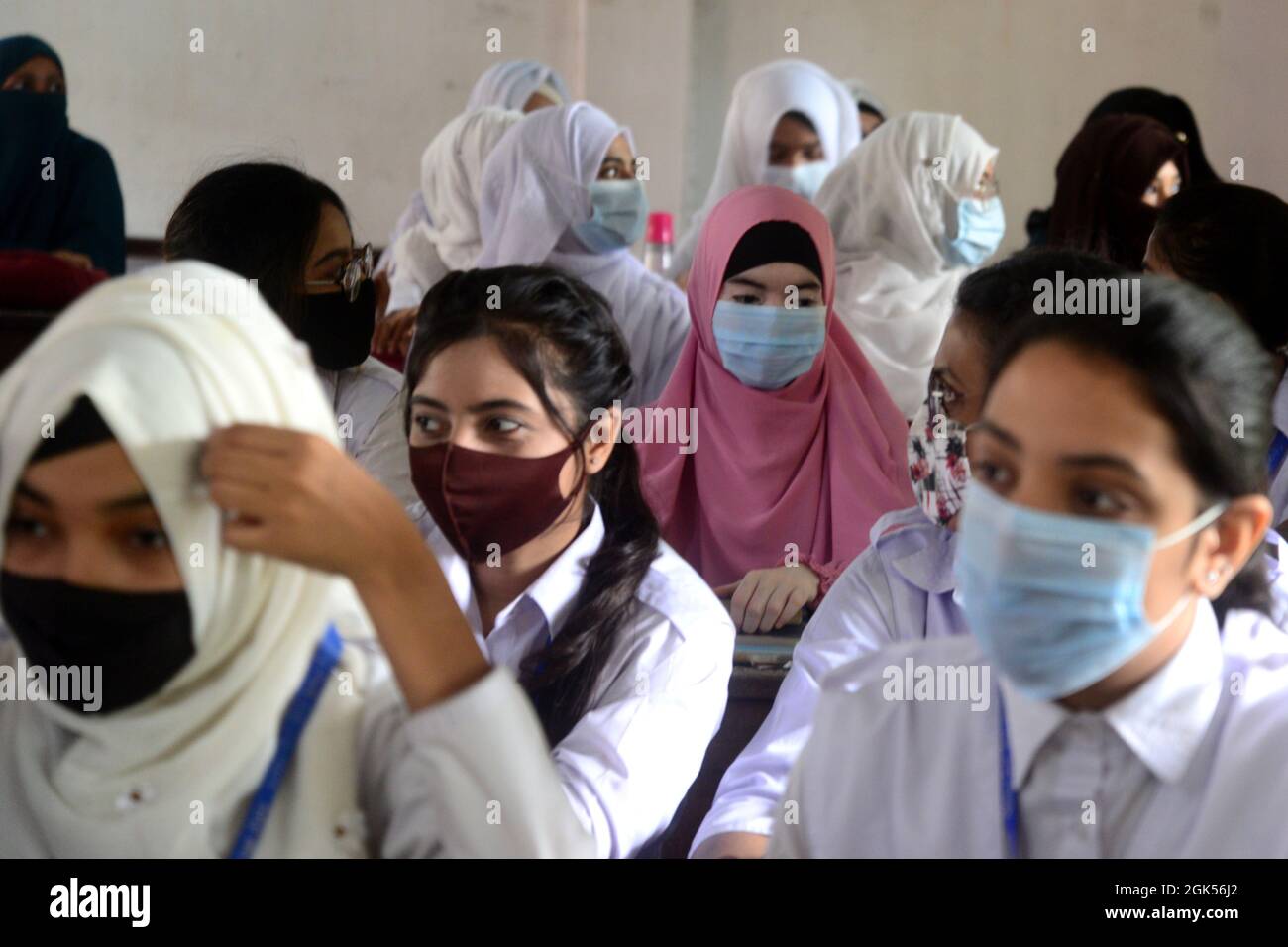 Students wearing face masks attend their class at the Azimpur ...