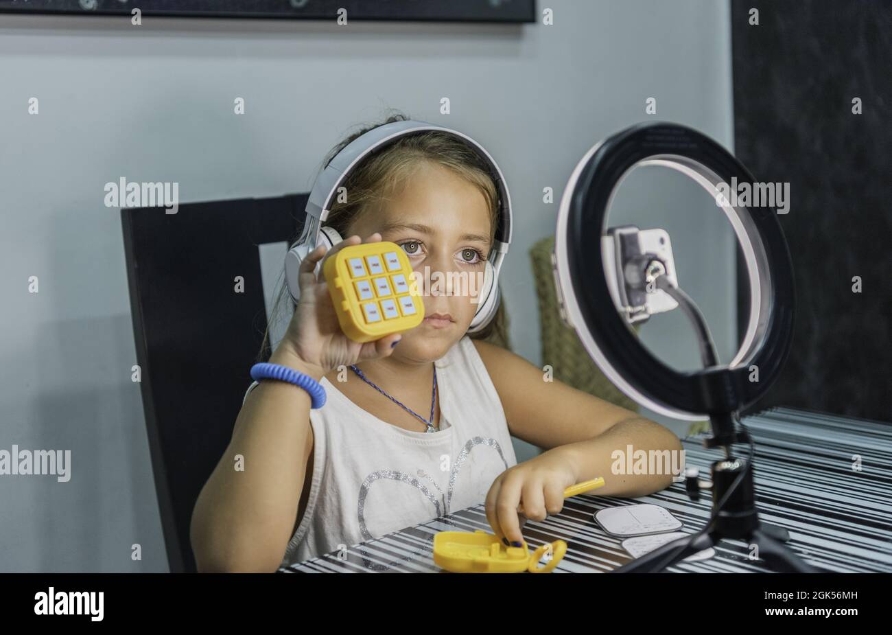 Little caucasian girl making a video tutorial Stock Photo - Alamy