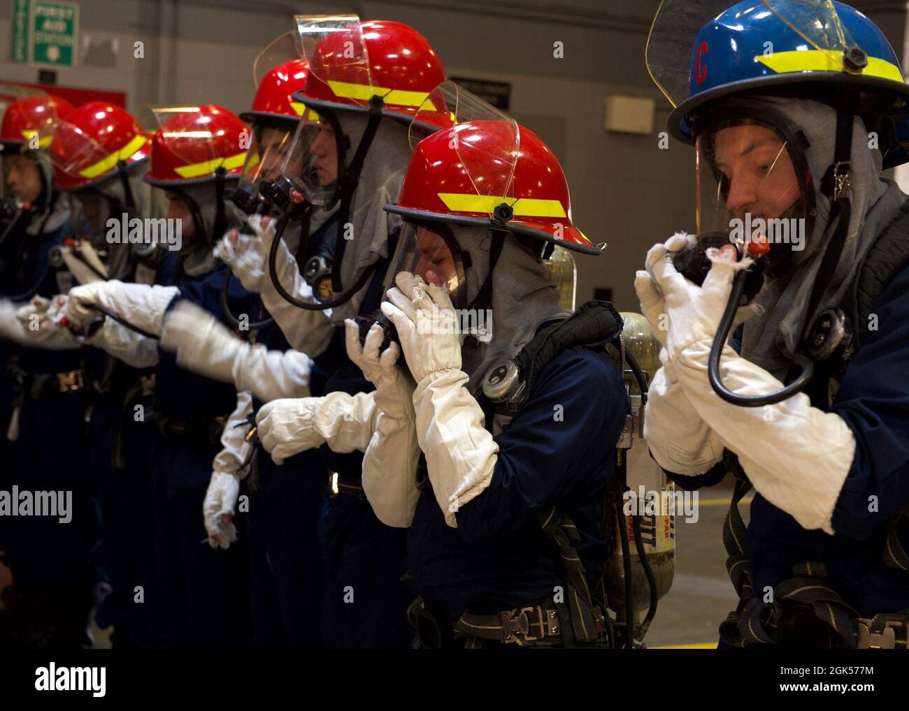 Recruits don firefighting equipment before a firefighting and damage ...