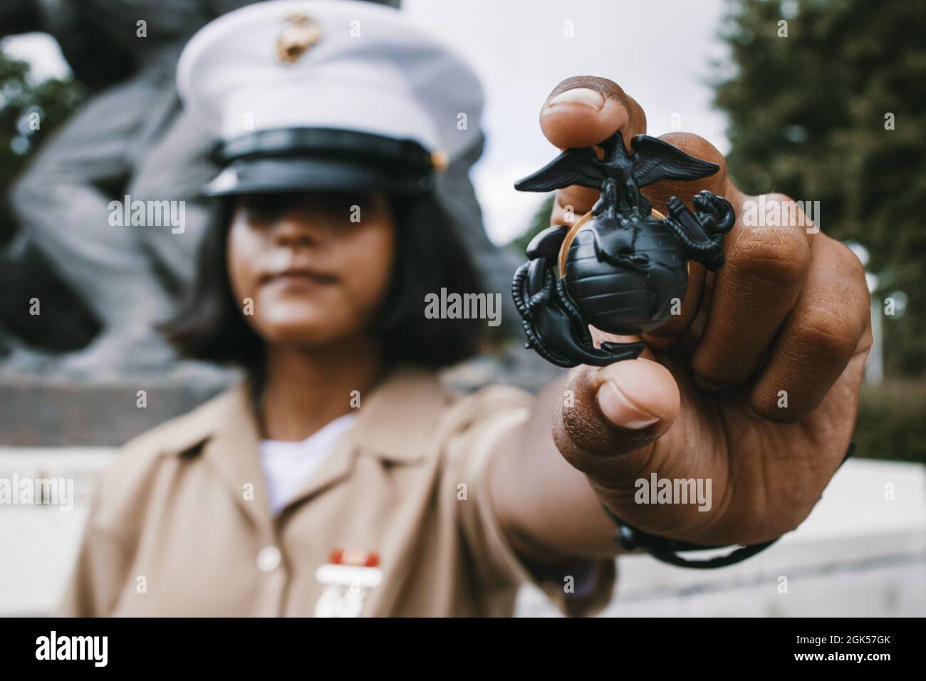 Private First Class Hernandez holds up her Eagle, Globe, and Anchor ...