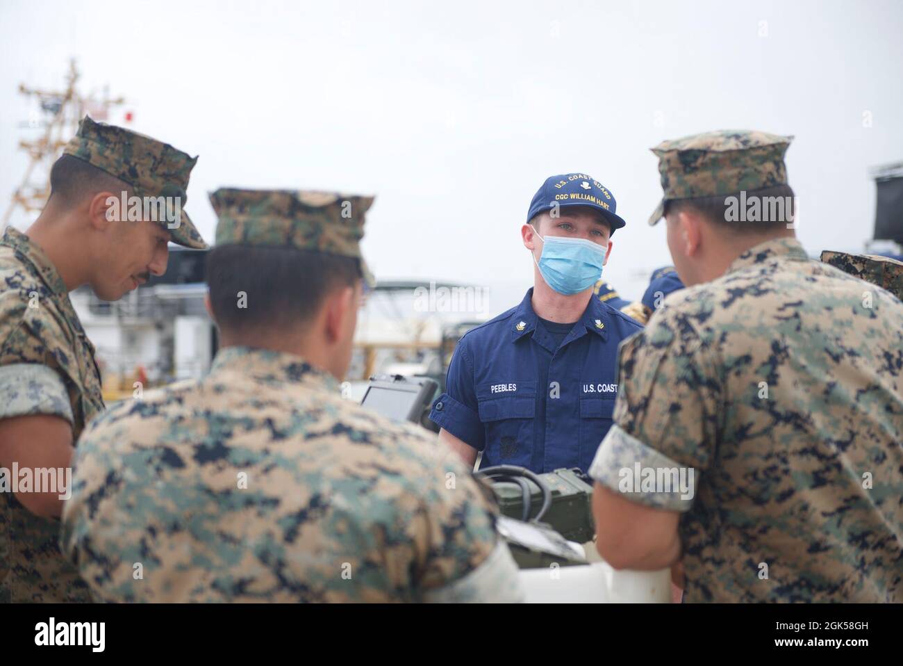 U.S. Coast Guard Petty Officer 2nd Class Joshua Peebles briefs the ...