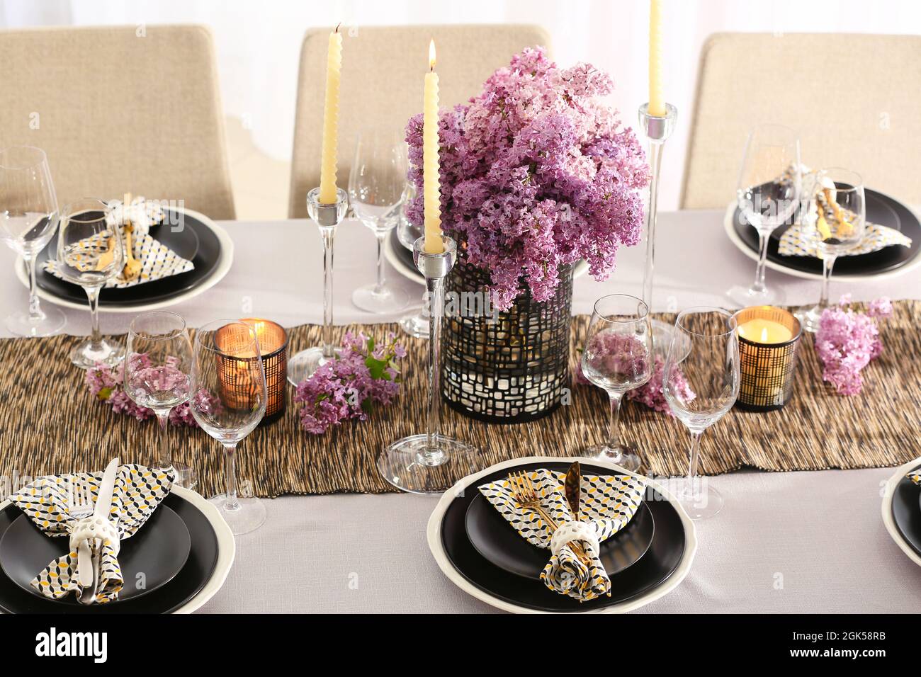 Beautiful table setting with lilac bouquet Stock Photo - Alamy