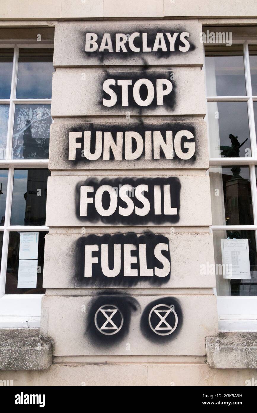 Graffiti including the extinction rebellion logo, written on a Barclays ...