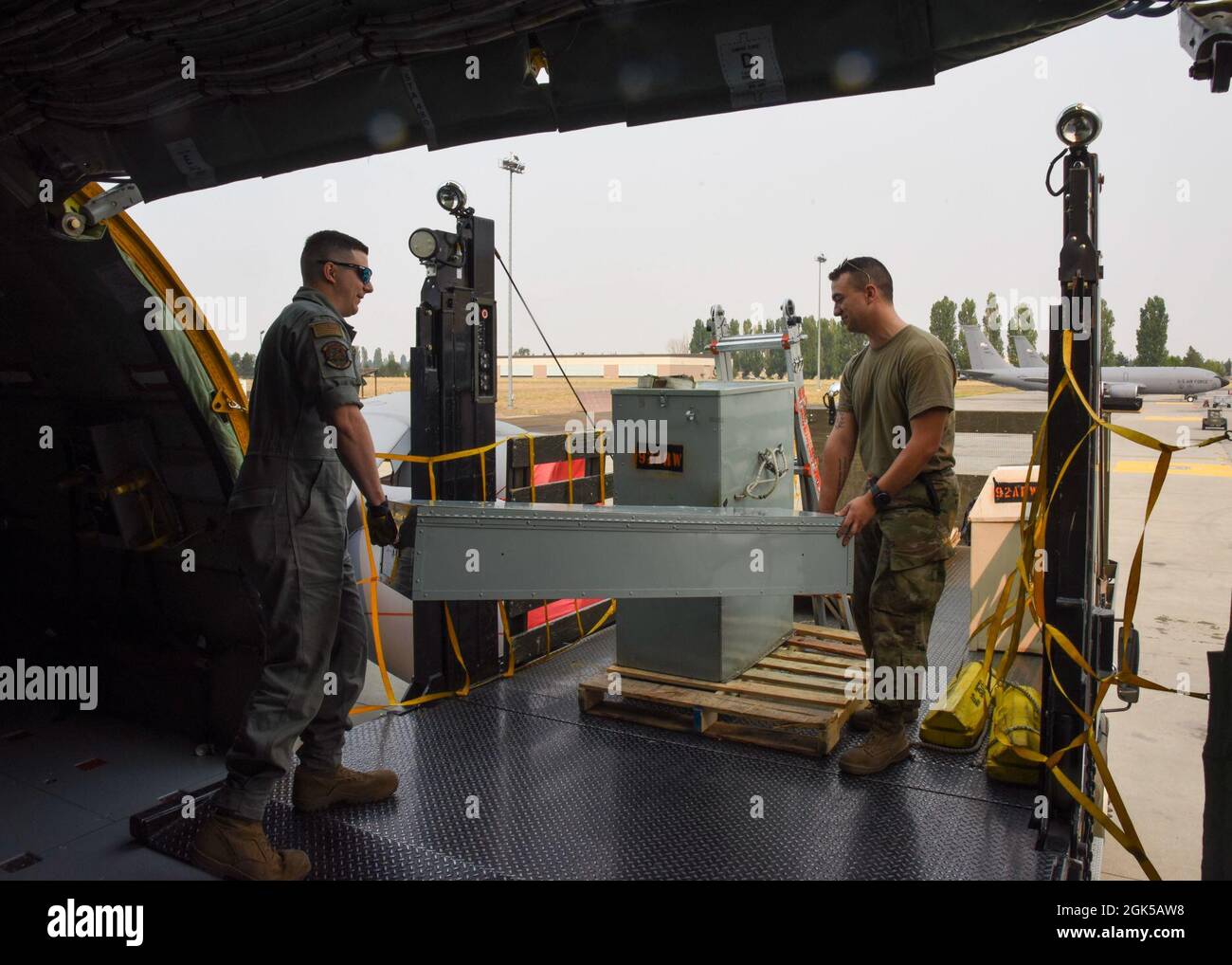 92nd Aircraft Maintenance Squadron Airmen load equipment off a KC-135 ...