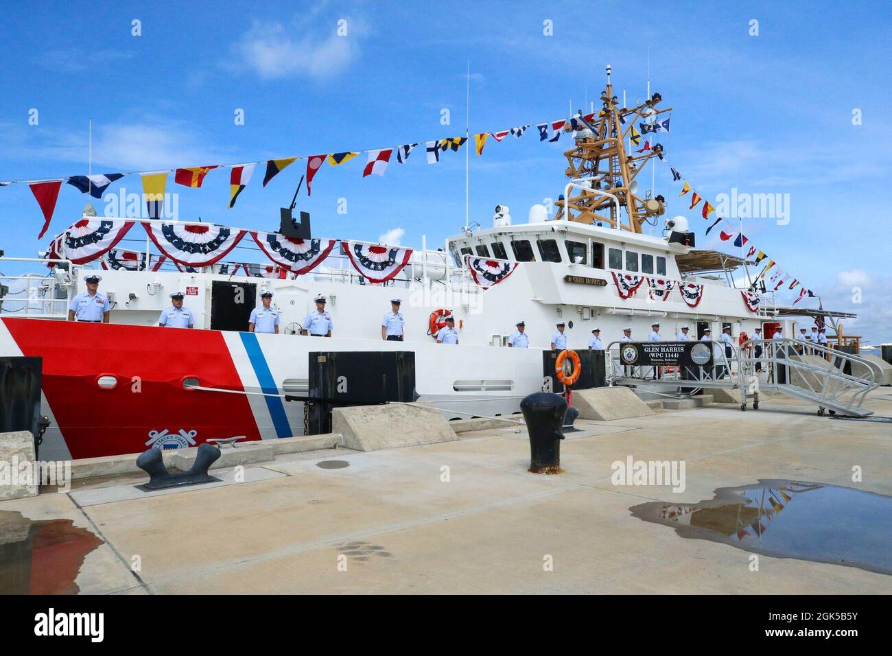 Members of the Coast Guard Cutter Glen Harris "man the rails" during ...