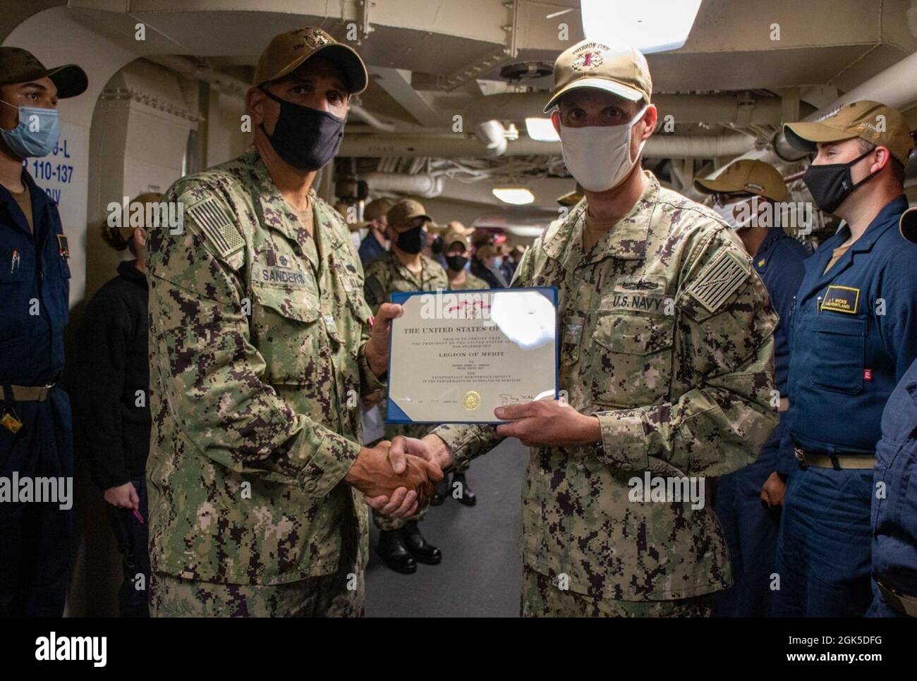 Capt. Karrey Sanders, left, receives a Meritorious Service Medal from ...
