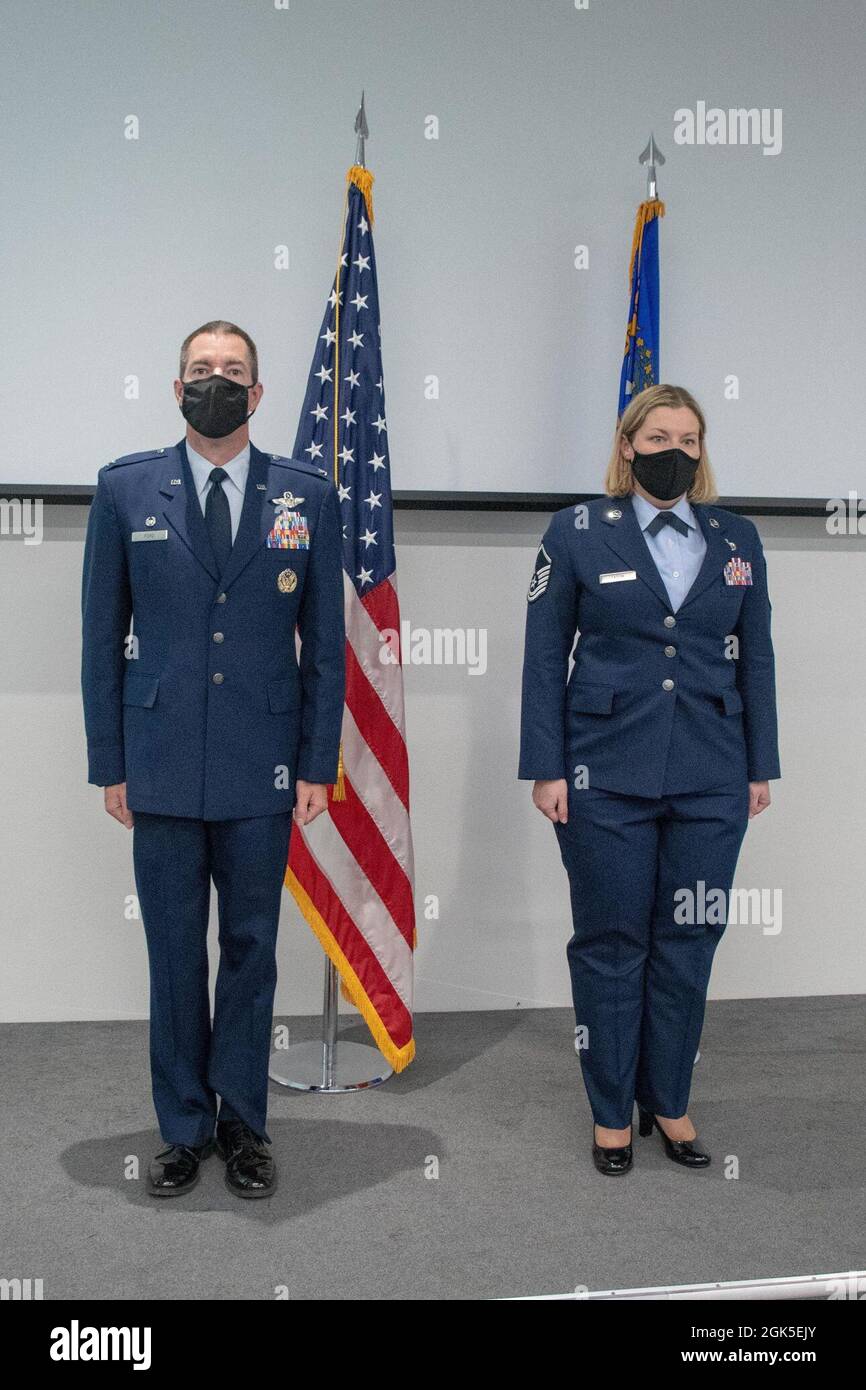 Col. Jeremy Ford and Master Sgt. Selena Tatum stand at attention during ...