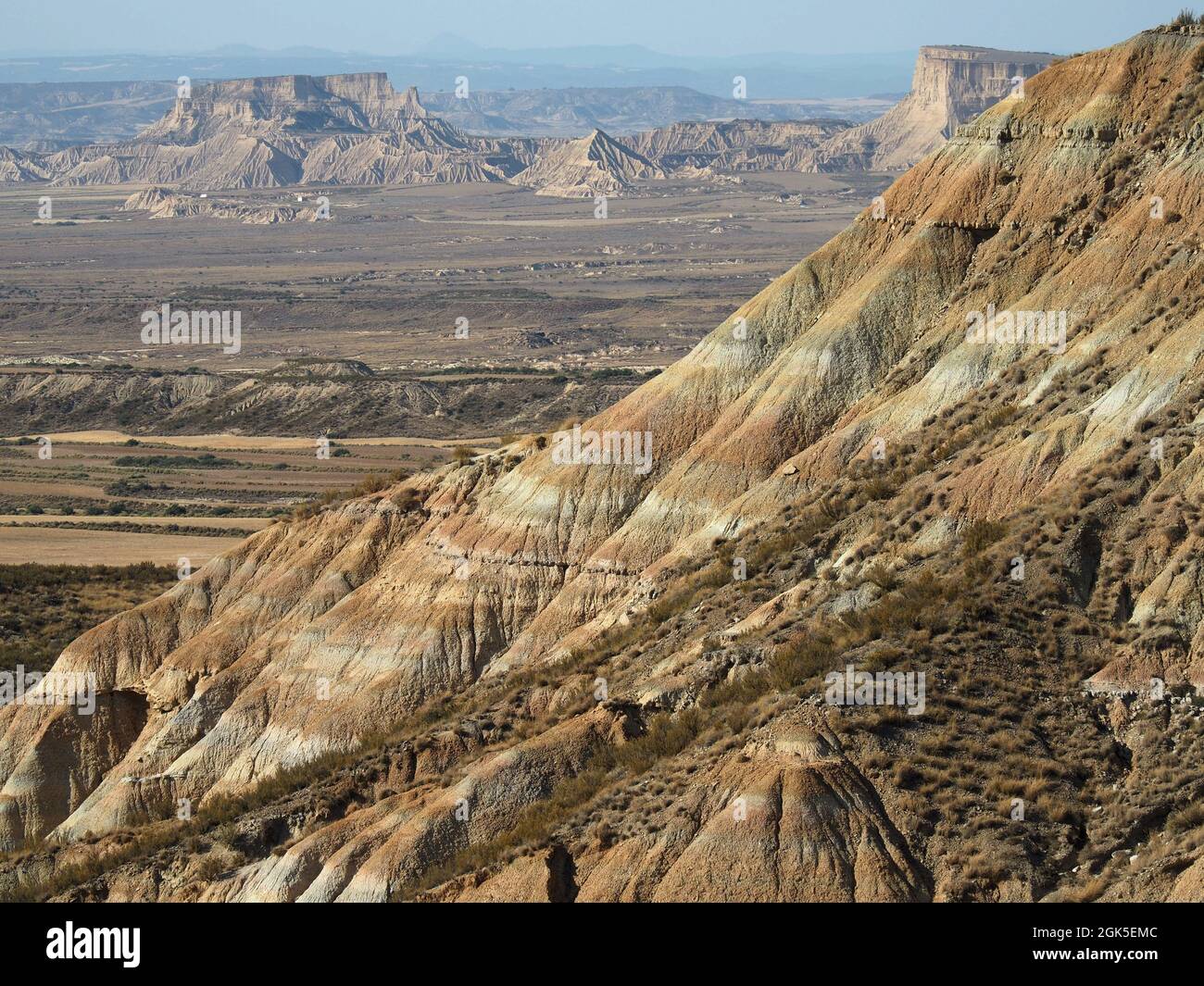 Shot of rocks and deserted sandy fields seen over the side of a ...