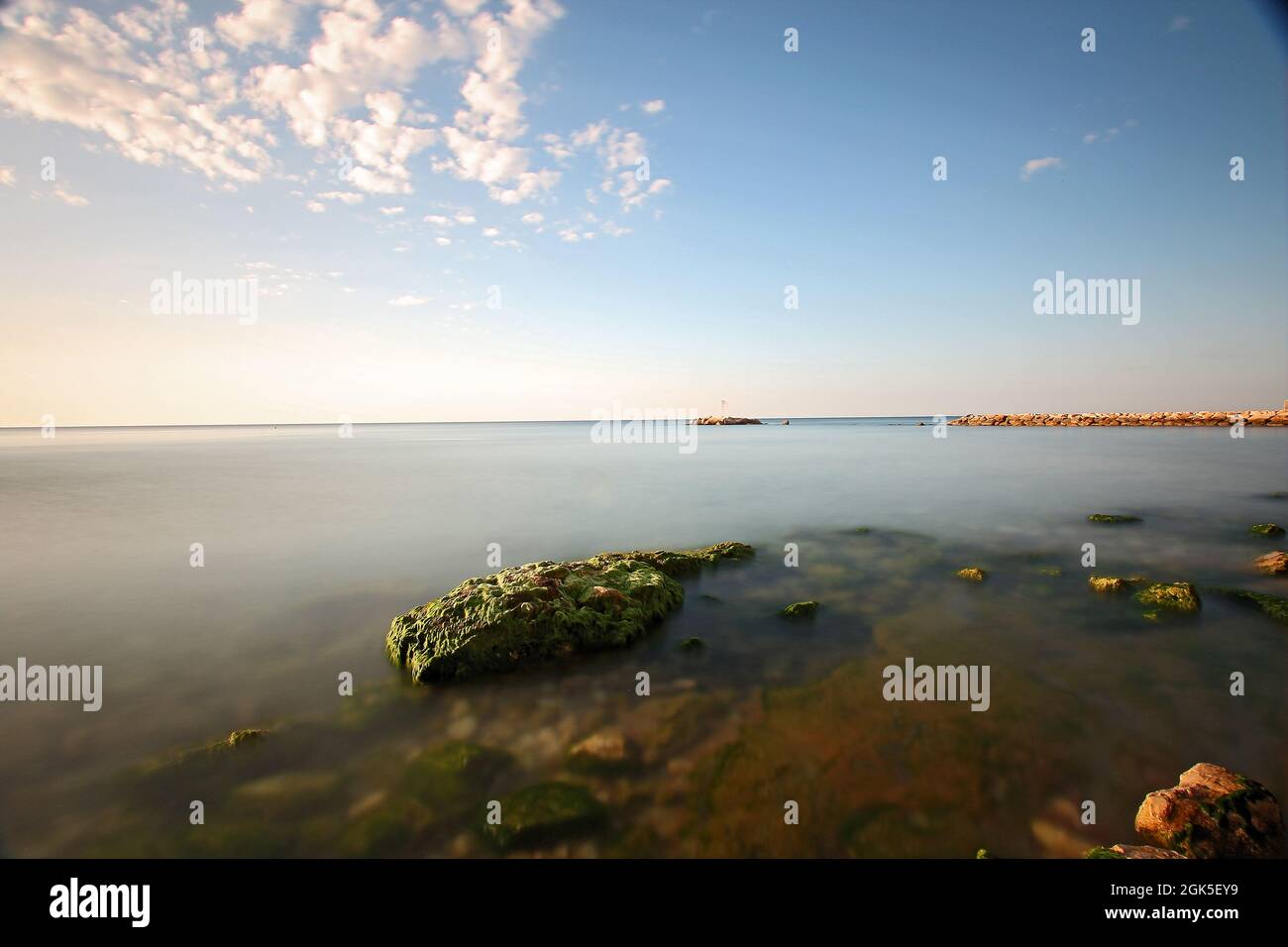 High angle shot of seascape with big rocks in the water and sunny sky ...