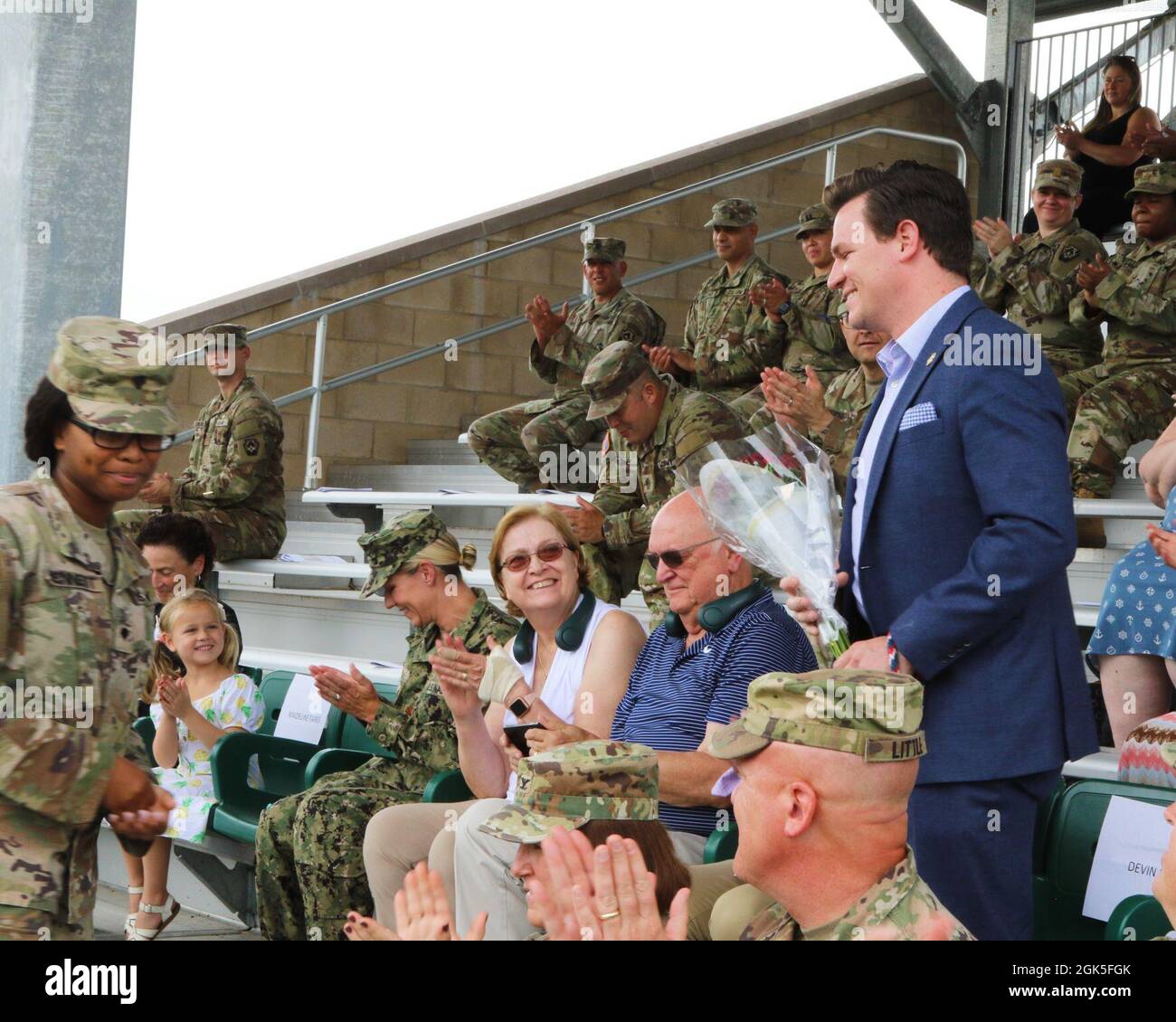 Devin Ruic receives flowers from the 728th Combat Sustainment Support ...
