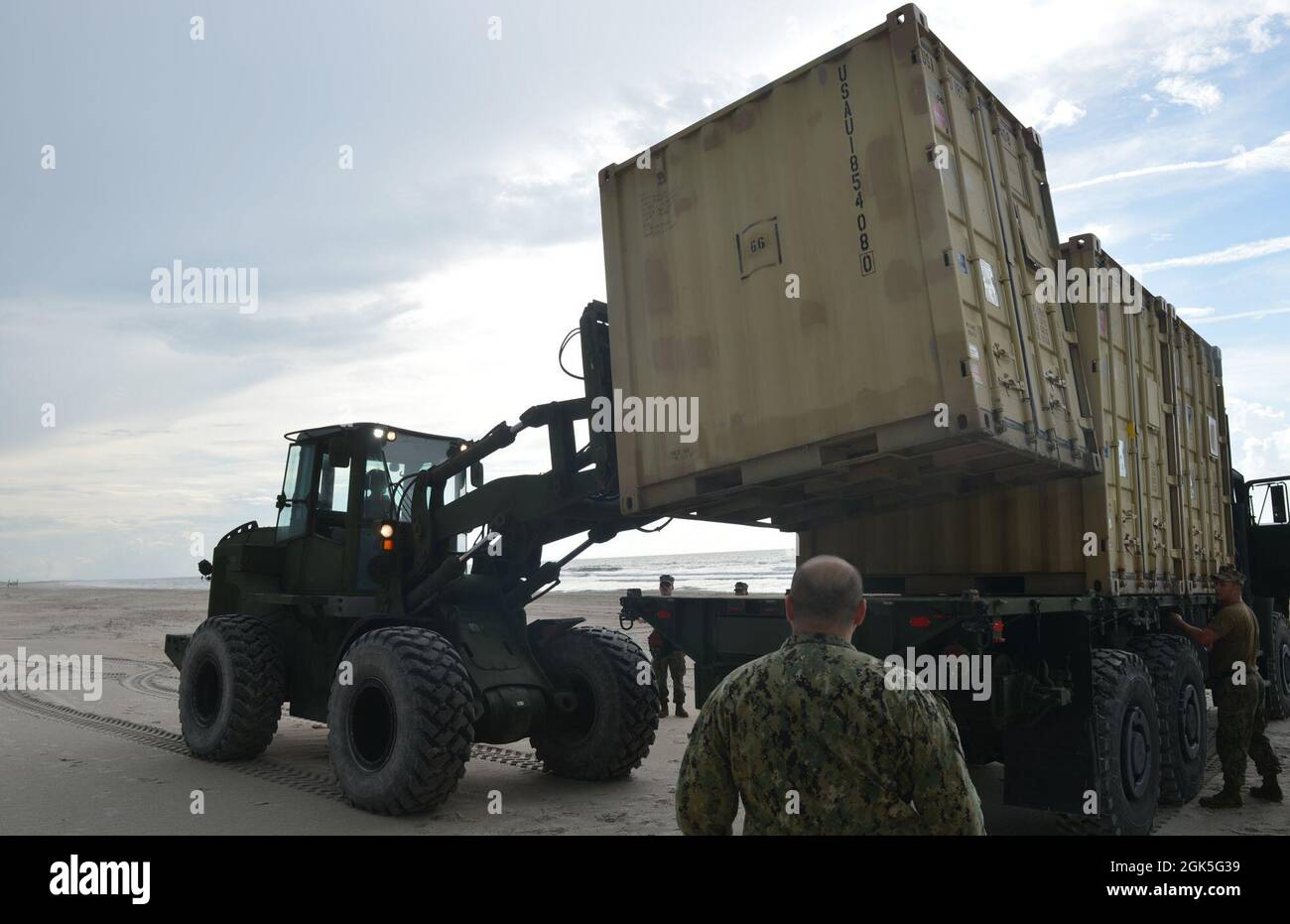 Sailors from Navy Cargo Handling Battalion ONE unload gear for the ...