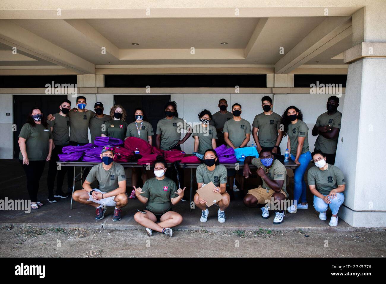 U.S. Marines and staff with Marine Corps Community Services pose for a ...