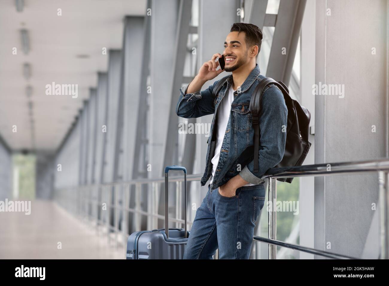 Roaming Abroad. Portrait Of Handsome Arab Man Talking On Cellphone In ...