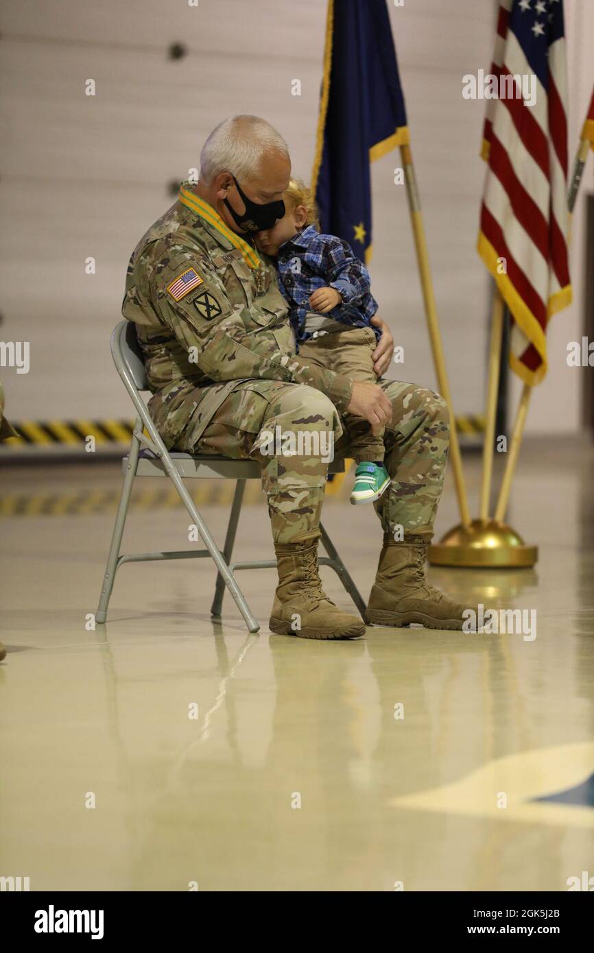 Chief Warrant Officer 5 Gregory Beach embraces his grandson during the ...