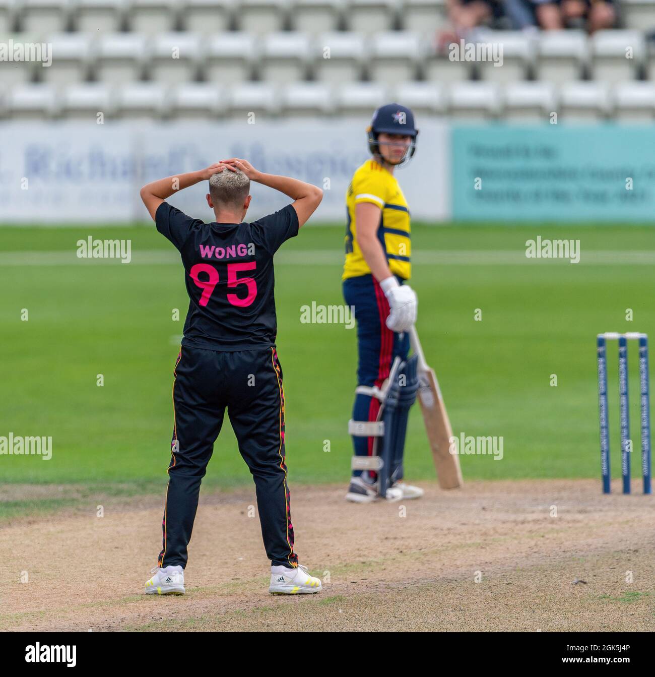 Issy Wong of Central Sparks reacts to her bowling watched by Alice ...