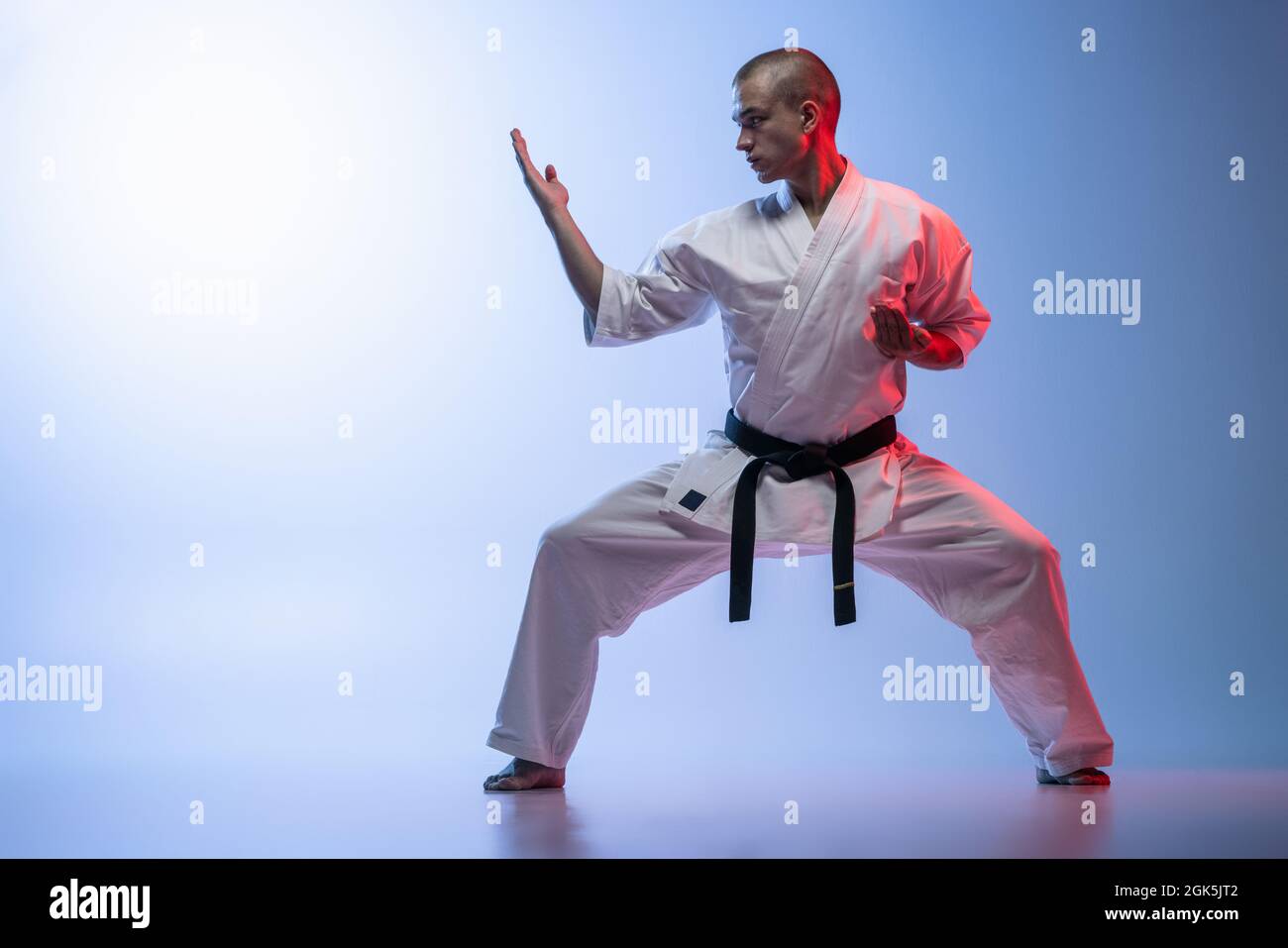 Side view image sportsman standing in a fight pose isolated over ...