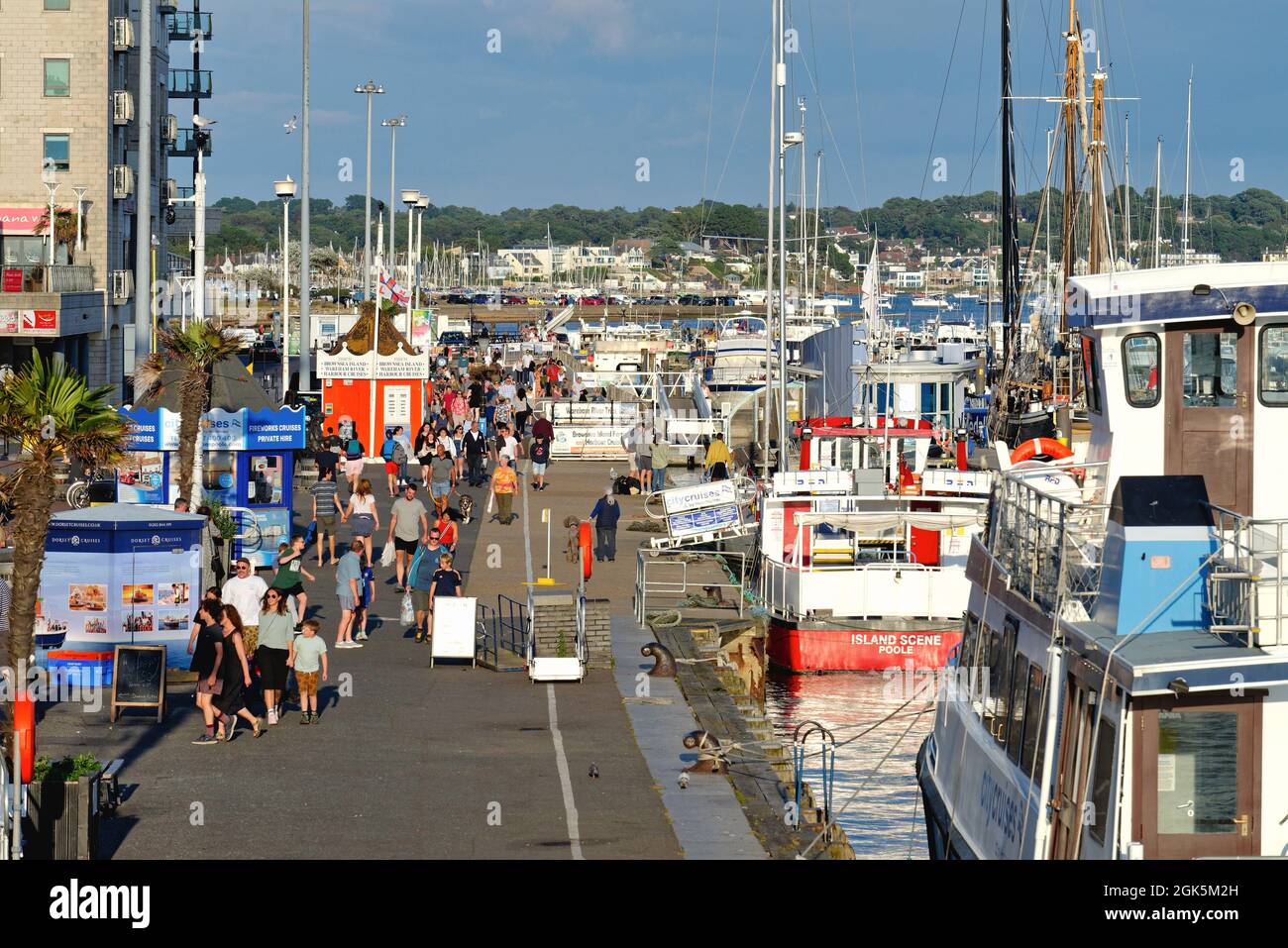 A busy waterfront on Poole Quay on a summers evening, Dorset England UK ...