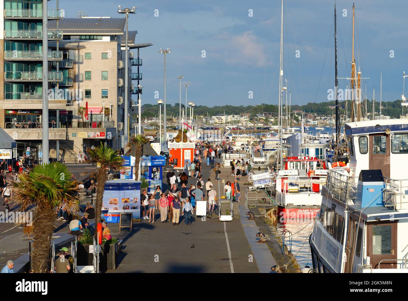 A busy waterfront on Poole Quay on a summers evening, Dorset England UK ...