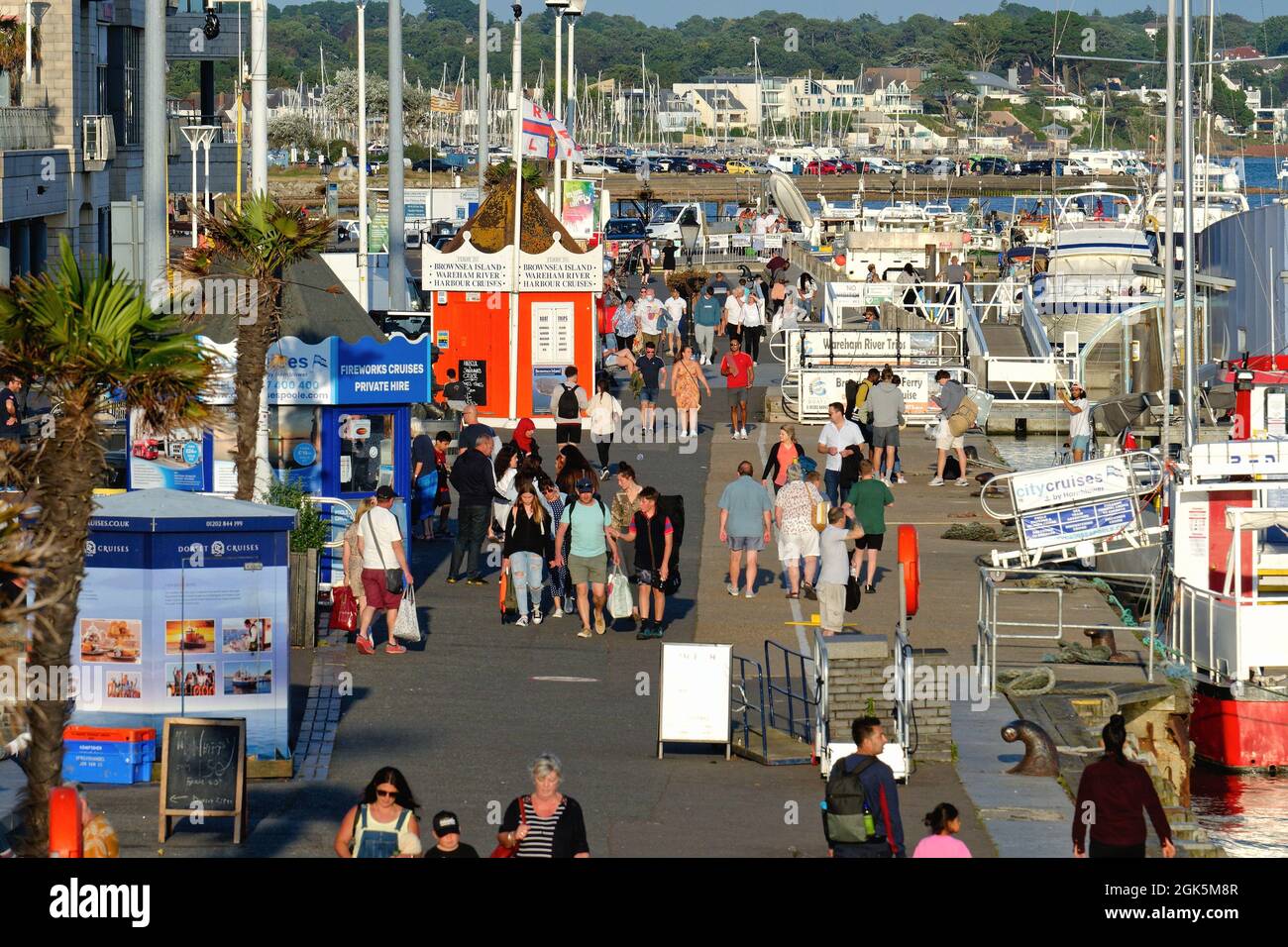 A busy waterfront on Poole Quay on a summers evening, Dorset England UK ...