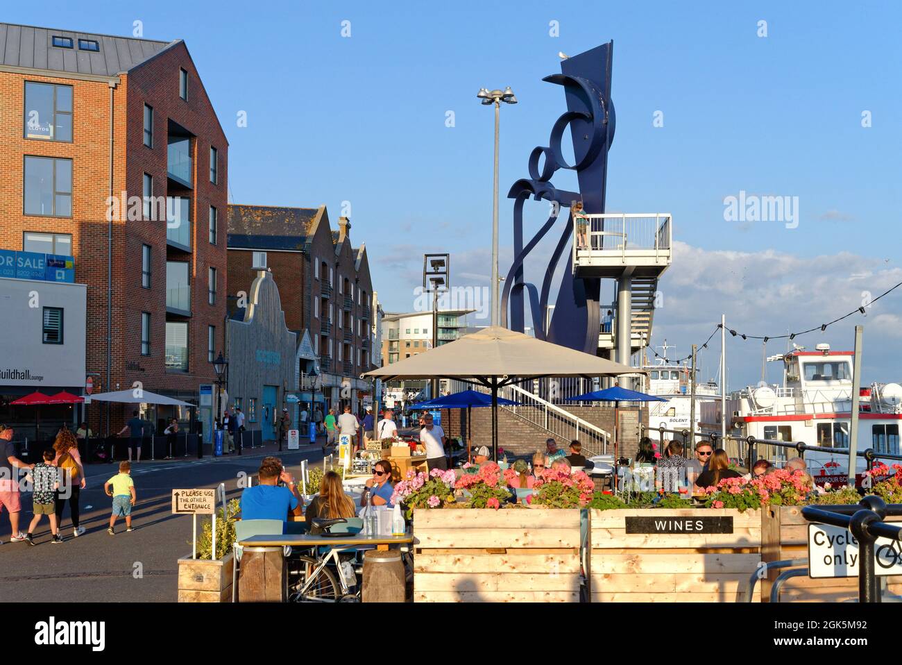 A busy waterfront on Poole Quay on a summers evening, Dorset England UK ...