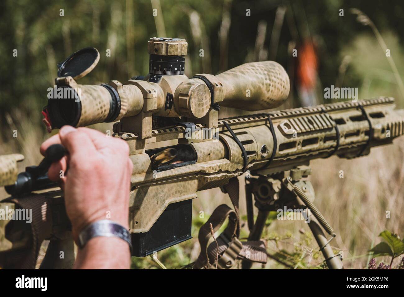 A sniper empties the chamber on his rifle after shooting a long ...