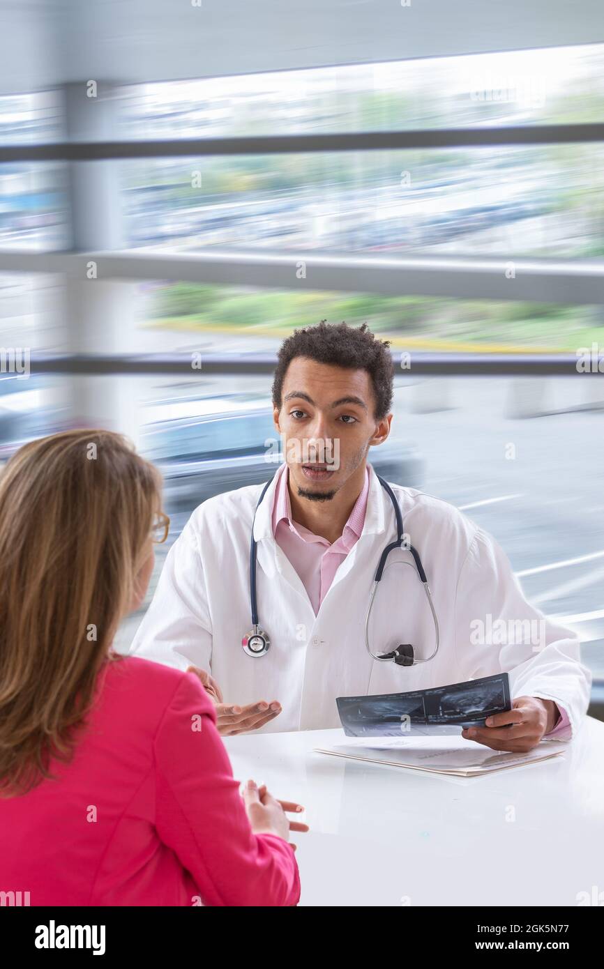Consultation of a young woman with a doctor, a radiologist Stock Photo ...
