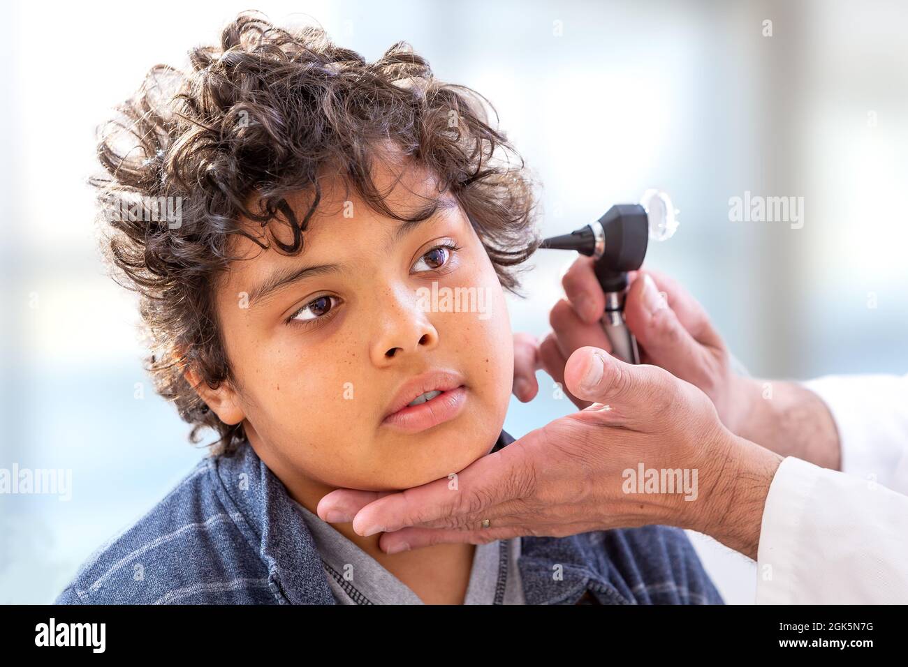 Doctor examining ears hi-res stock photography and images - Alamy