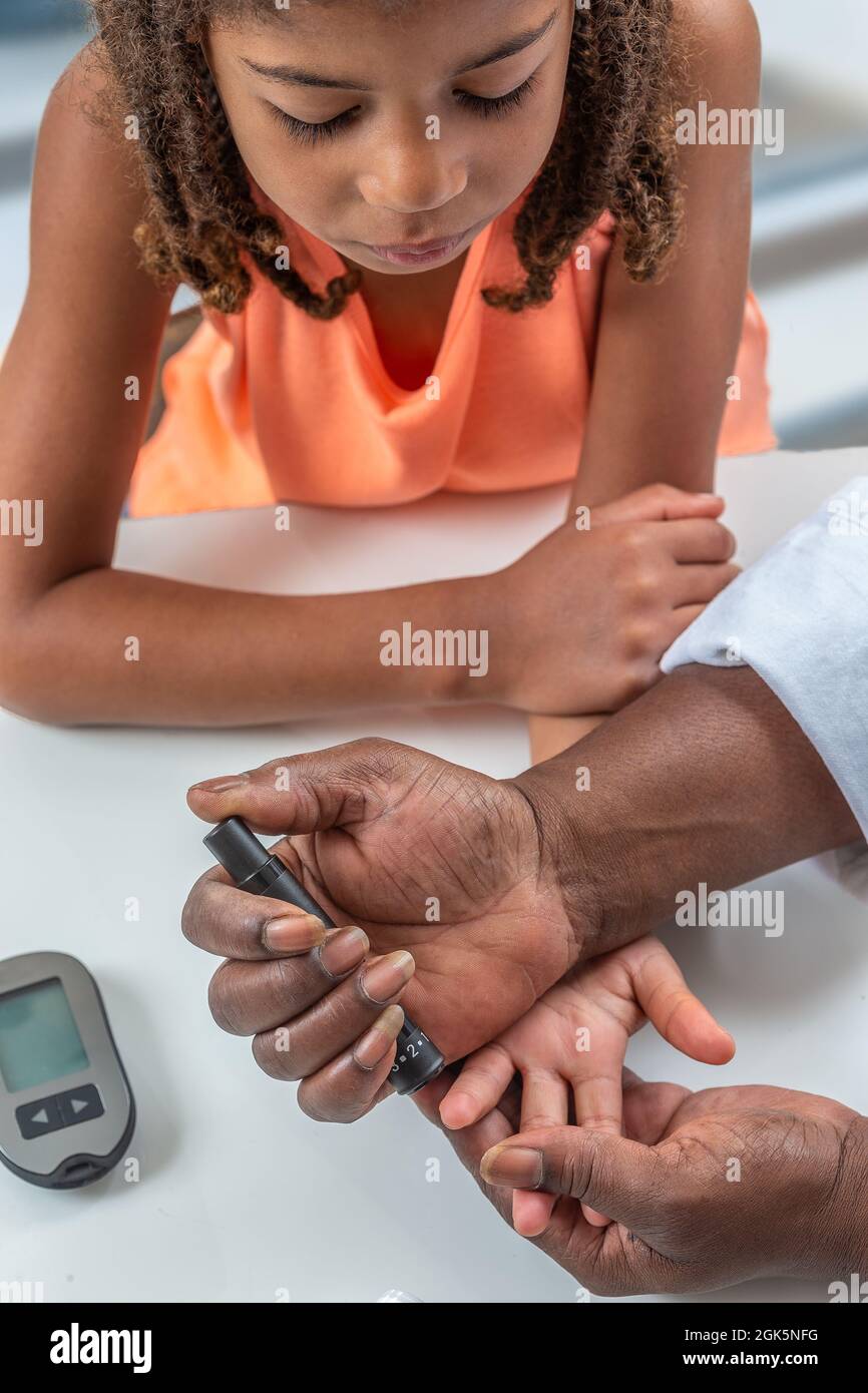 Concept children diabetes children with glucometer learning to check ...