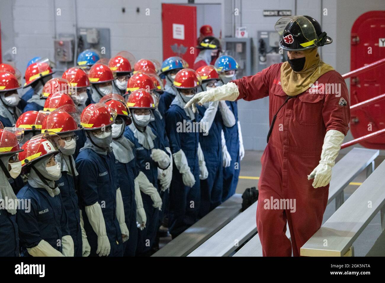 Recruits await instruction before a firefighting training exercise ...