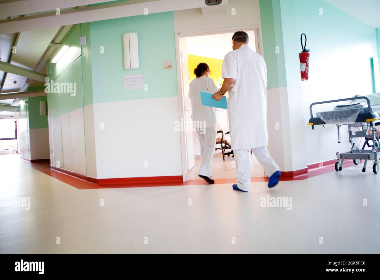Doctor and nurse entering female patient room in hospital Stock Photo ...