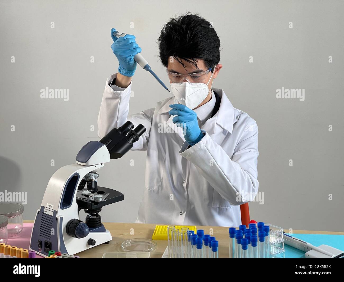 Laboratory technician carrying out experiments on different types of ...