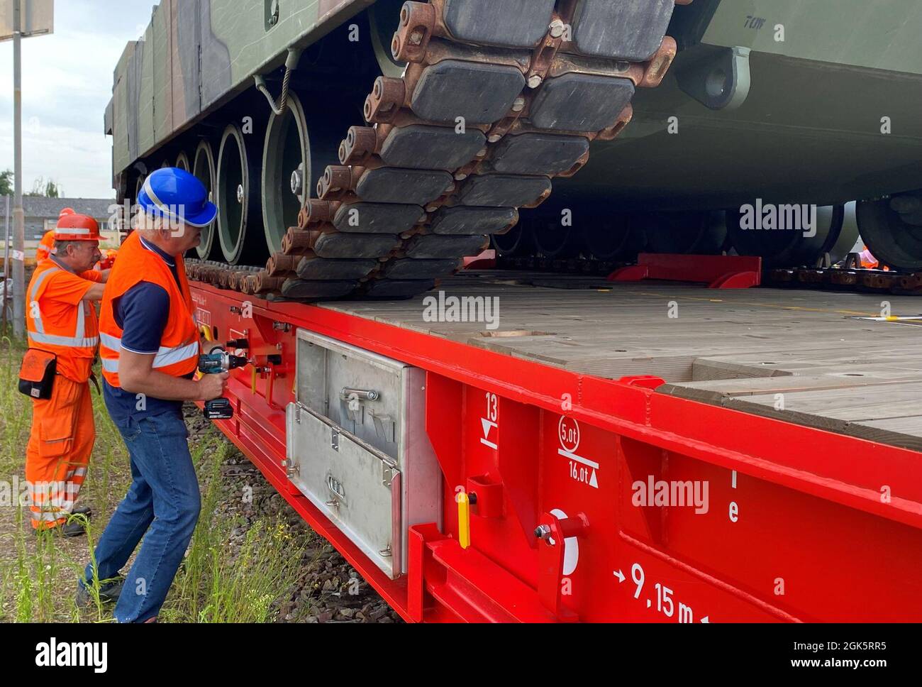 A German railway employee uses a power drill to deploy an automated ...