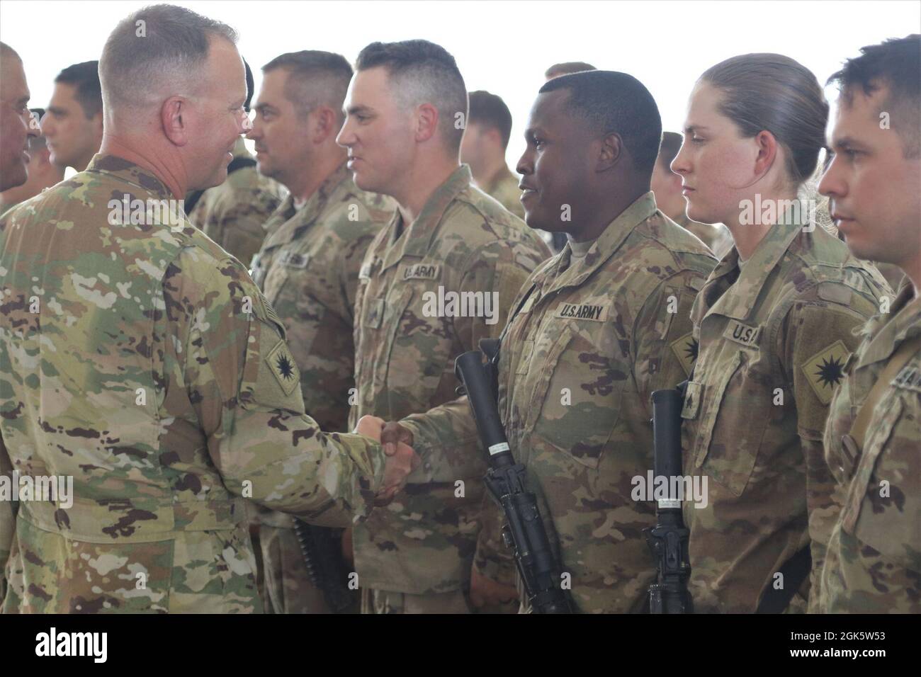 Task Force Phoenix Commander Col. Alan Gronewold congratulates a ...