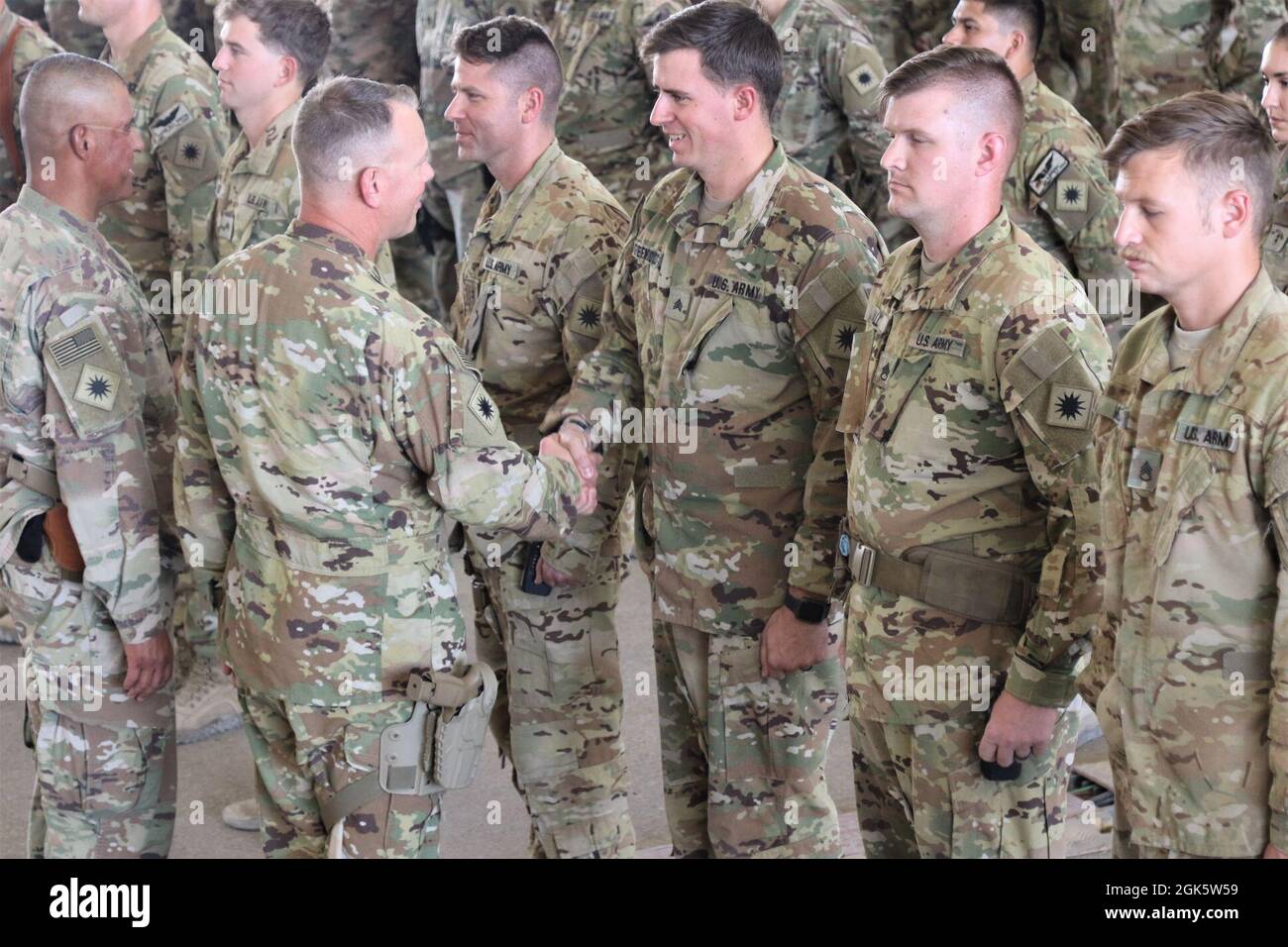 Task Force Phoenix Commander Col. Alan Gronewold congratulates a ...