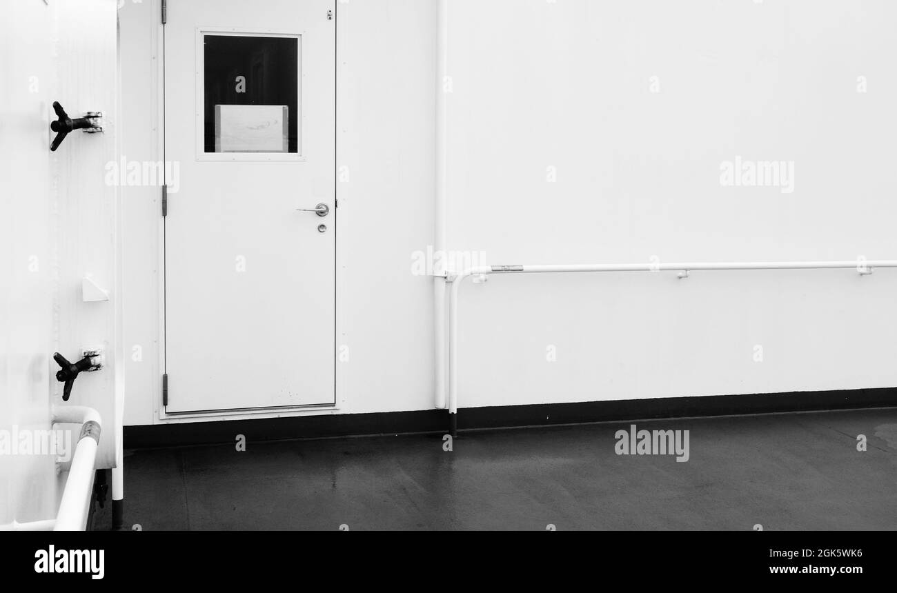 Clean white modern vessel ship closed door black deck floor with air ...