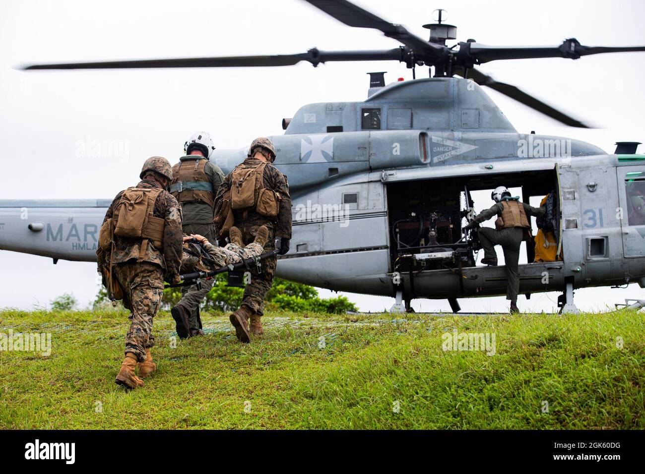 U.S. Marine Corps with Marine Wing Support Squadron (MWSS) 172, load a ...